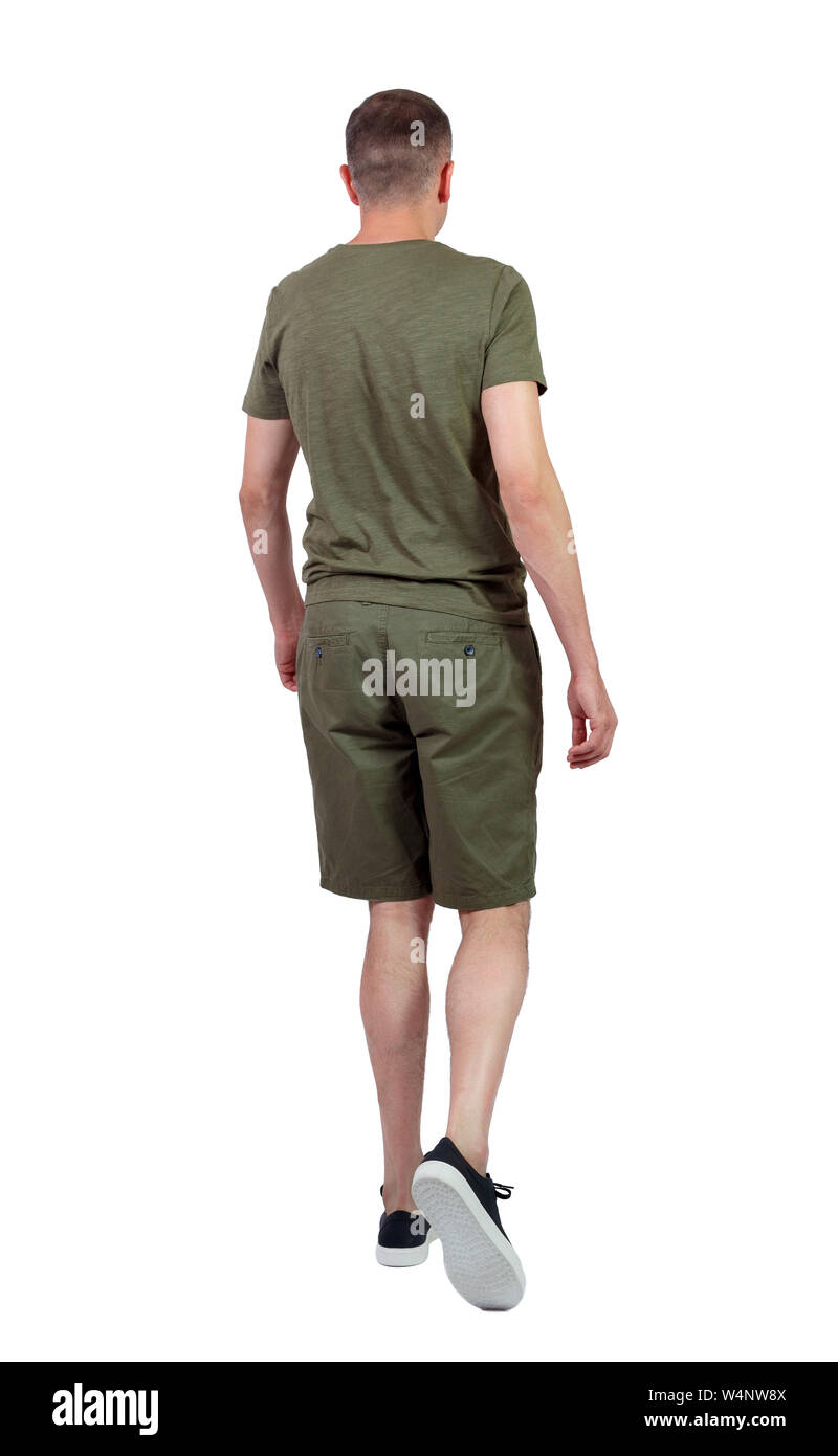 Back view of going handsome man in shorts. walking young guy . Rear ...