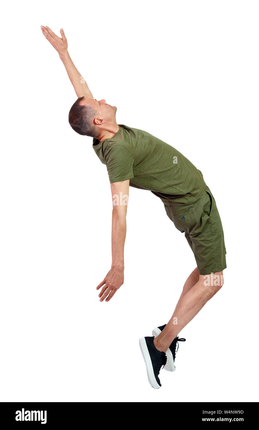Side view of a man dancing in shorts. The guy is balancing. Rear view ...