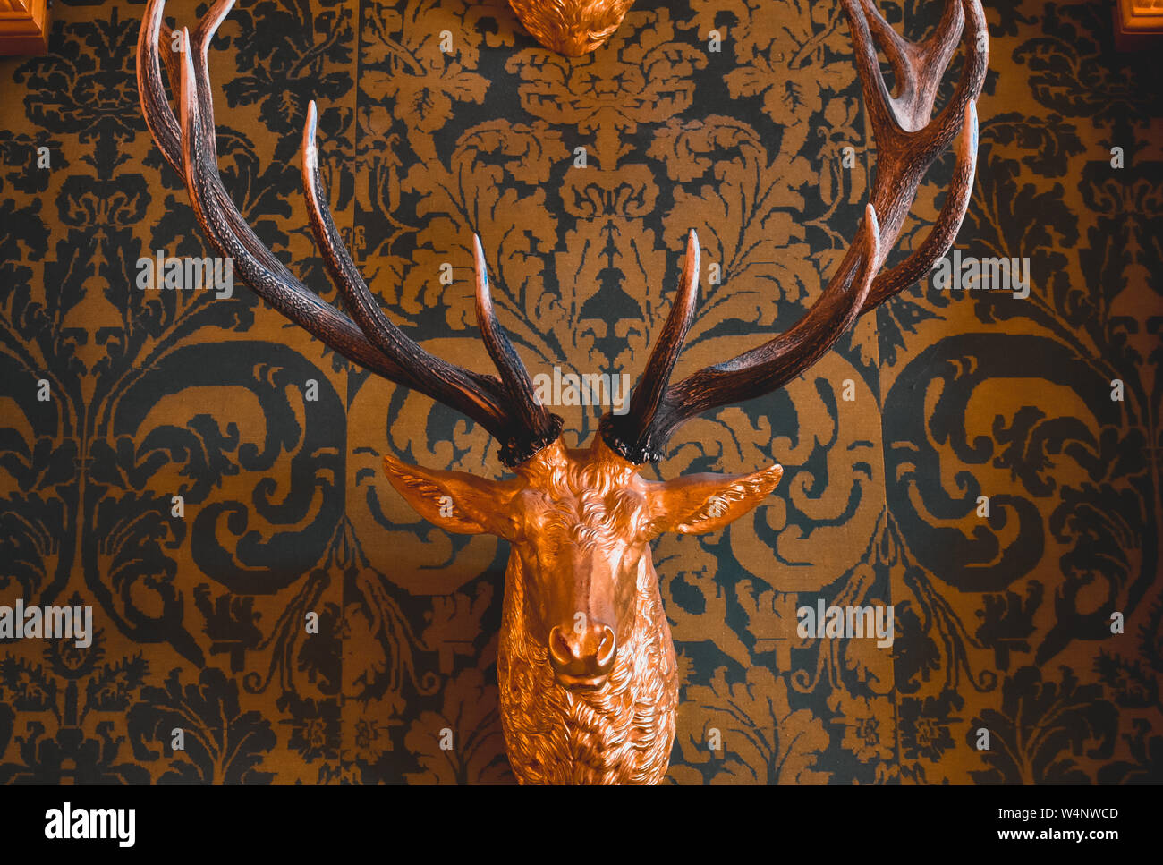 Decorative fake deer head with a patterned background paper. Edited ...