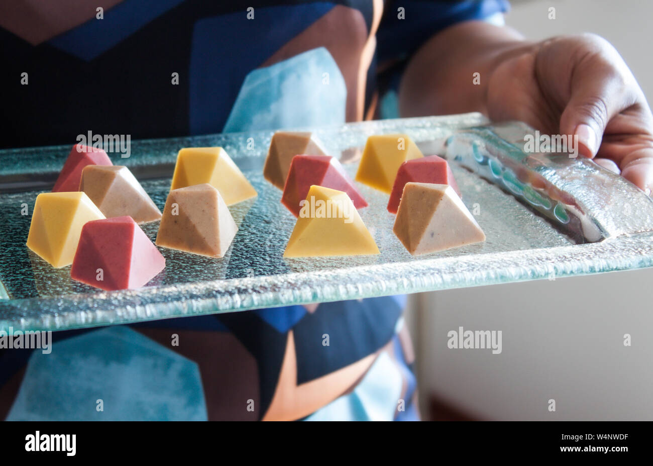 Colorful chocolate vegan pralines on glass tray Stock Photo - Alamy