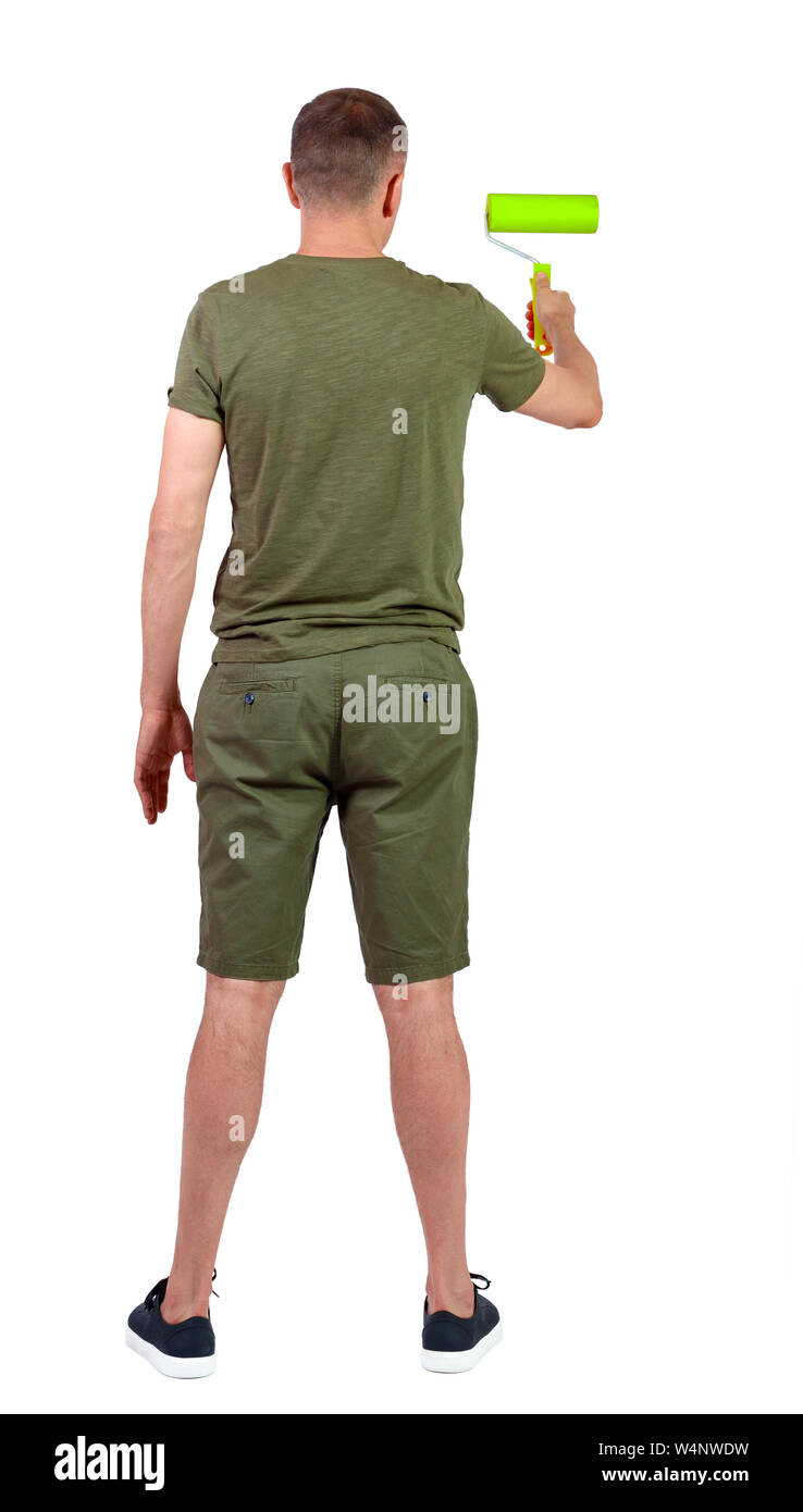 Back view of a man who paints the paint roller. rear view people ...