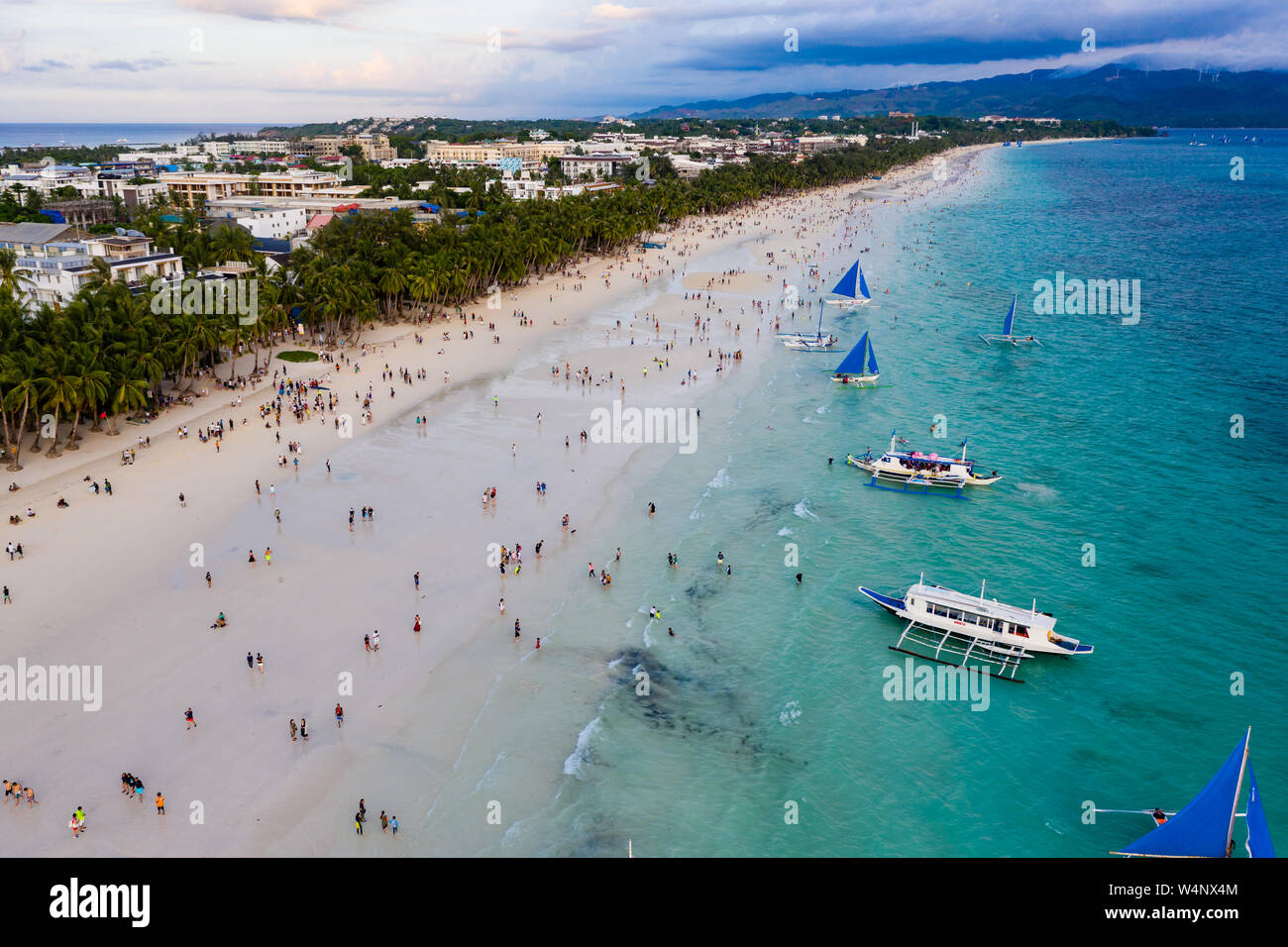 Crowds gathering on Boracay Island's White Beach to watch the sunset ...