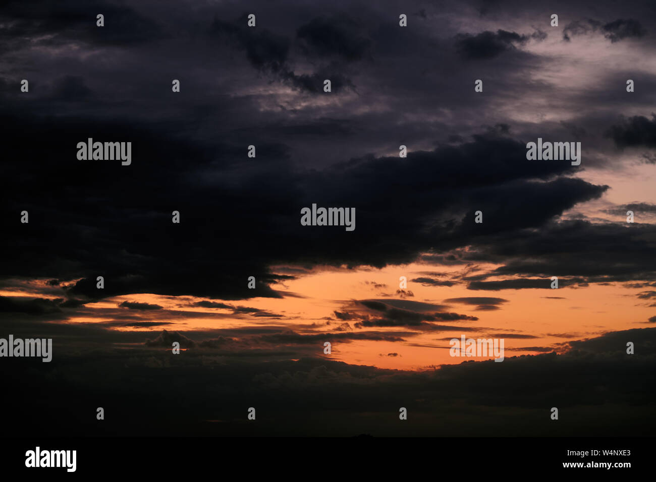 Beautiful sunset - dark sky with clouds and sunlight Stock Photo - Alamy