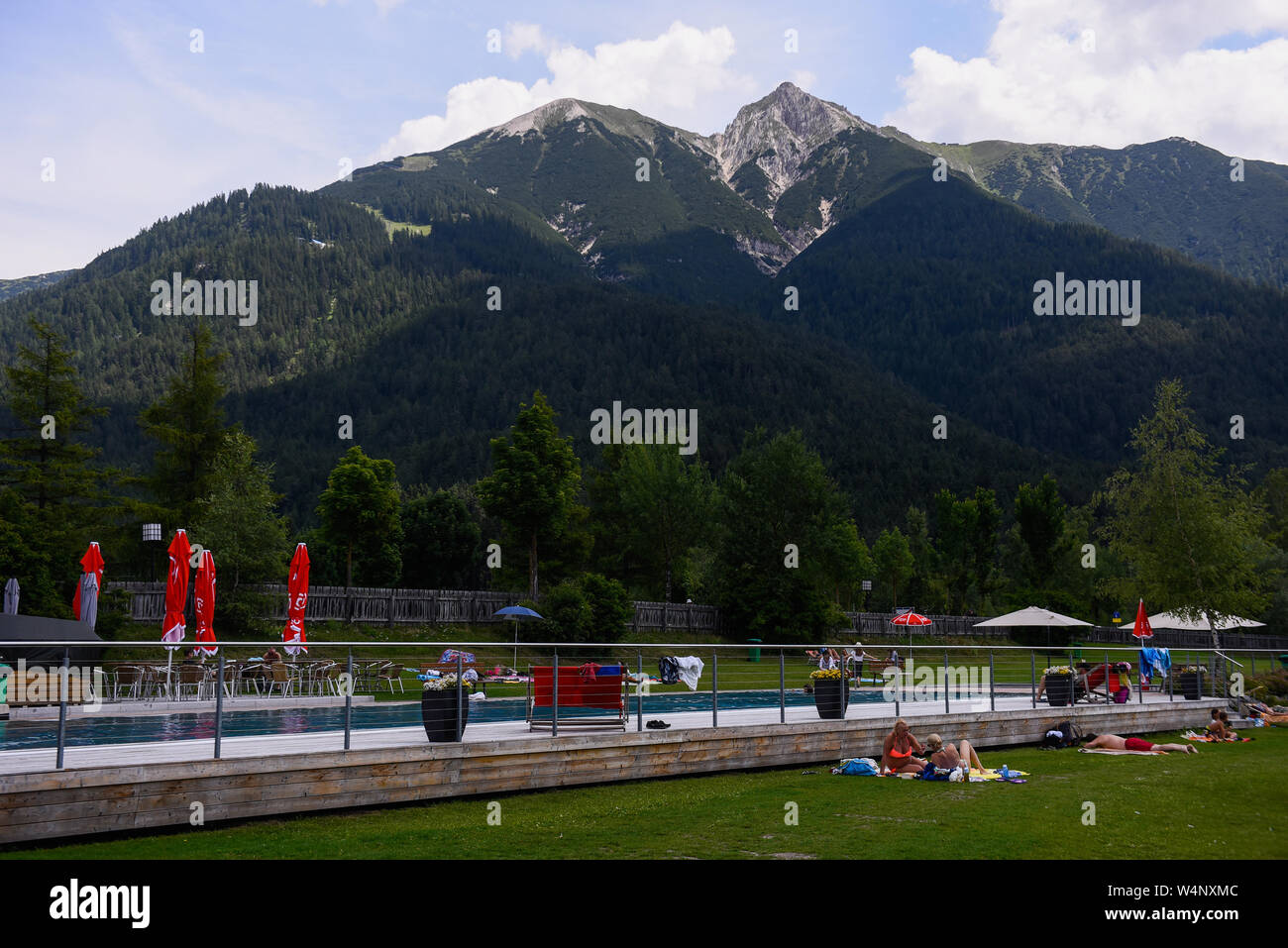 People take a sun bath at the Wildsee lake. Tyrol is a western Austrian ...