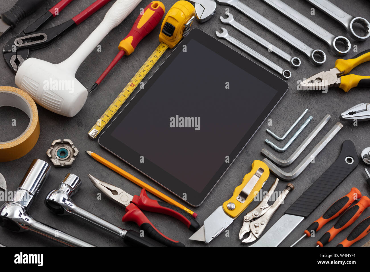 Tablet with empty screen and construction tools around Stock Photo - Alamy