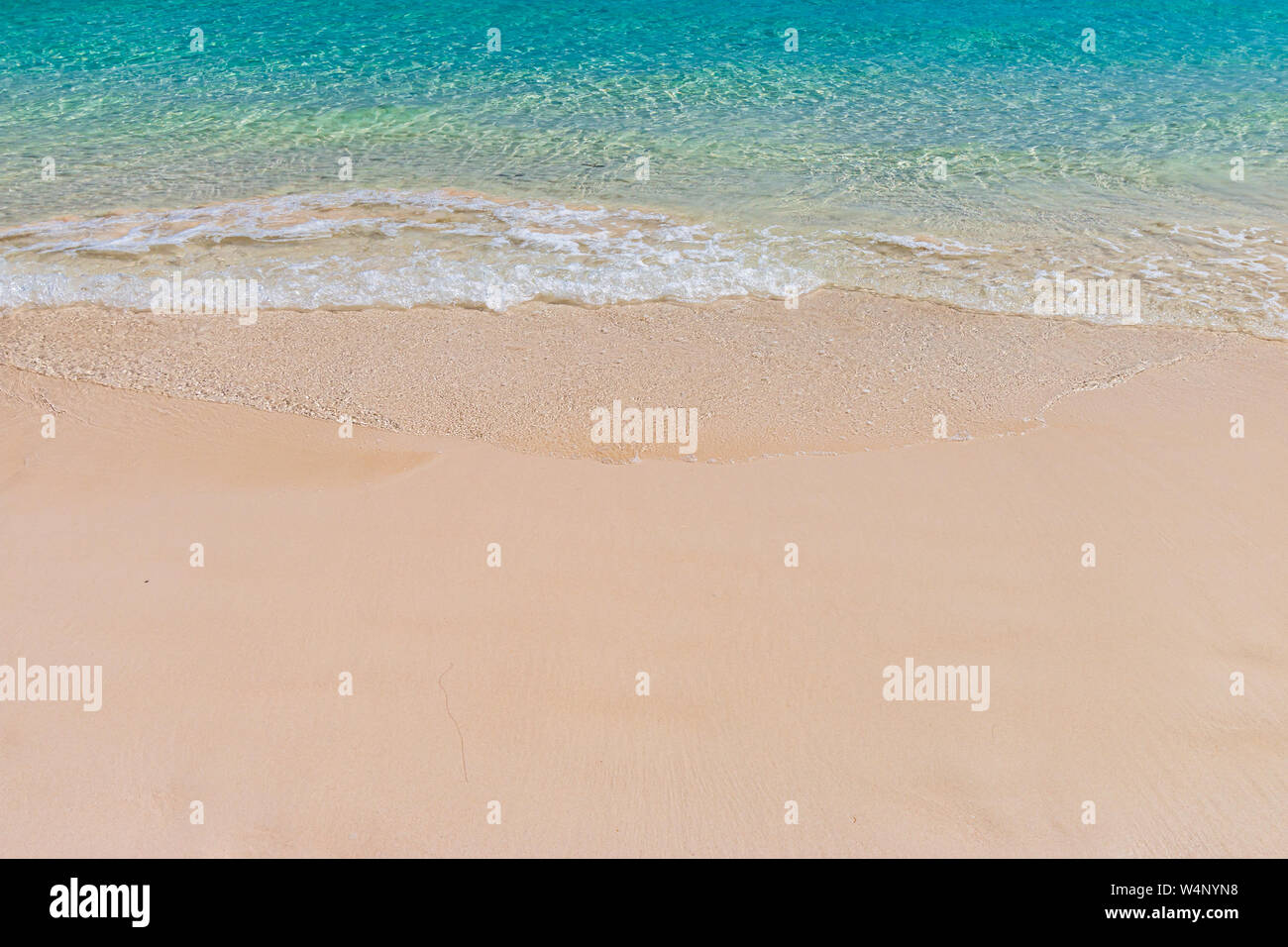 Gentle ocean waves lapping onto a sandy, tropical beach. Relaxing ...