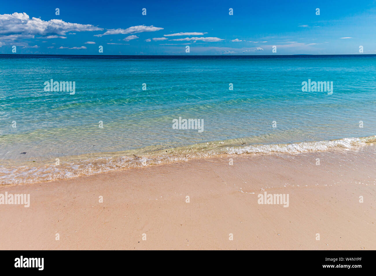 Gentle ocean waves lapping onto a sandy, tropical beach. Relaxing ...