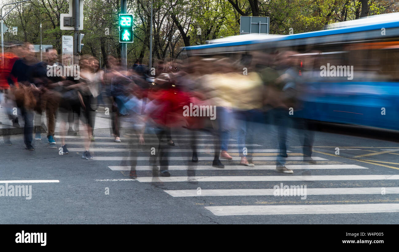 Traffic flows of people and cars at the busy city crossroad Stock Photo ...