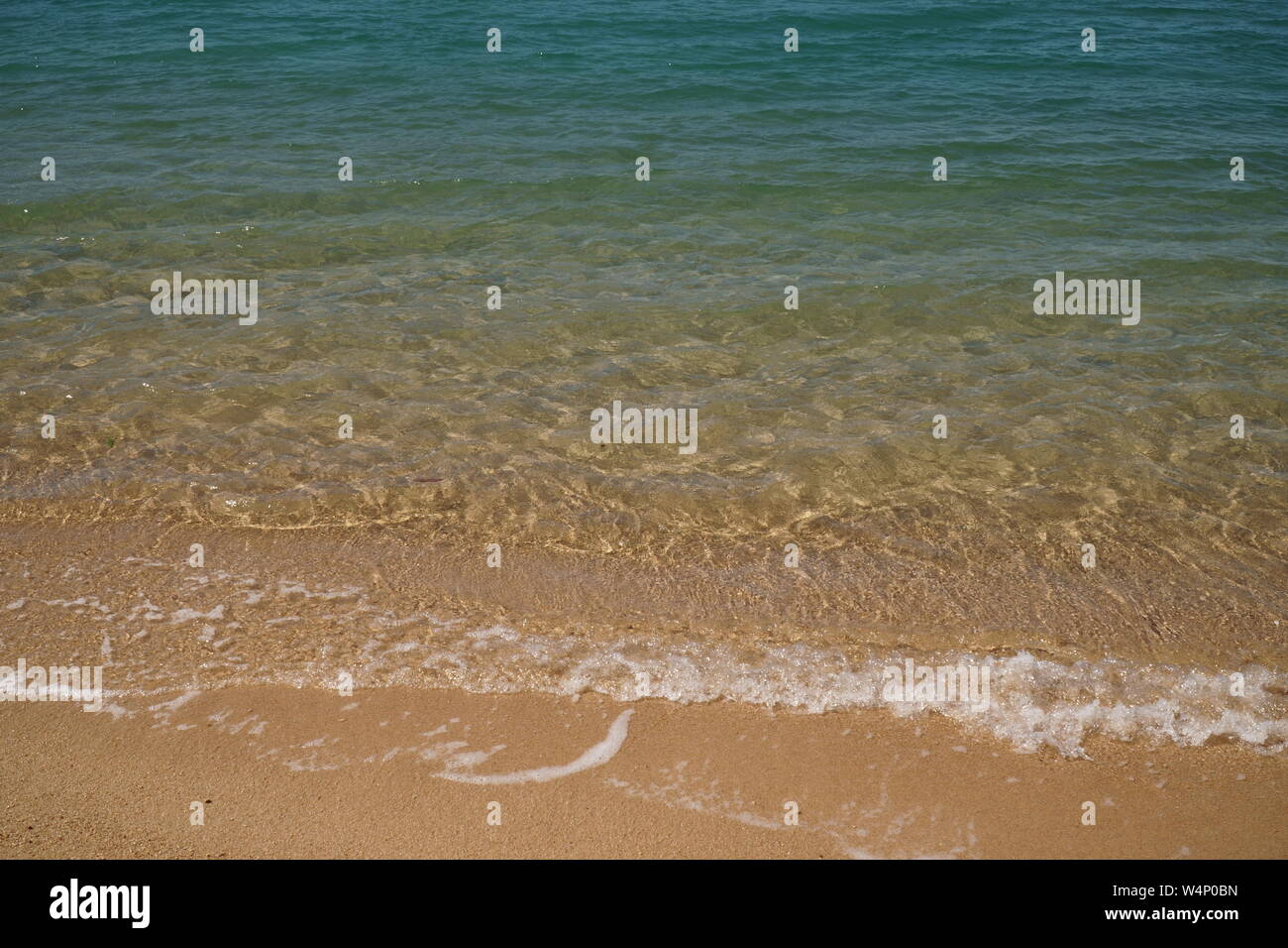 Perfect clear blue ocean water surf and yellow clean beach Stock Photo ...