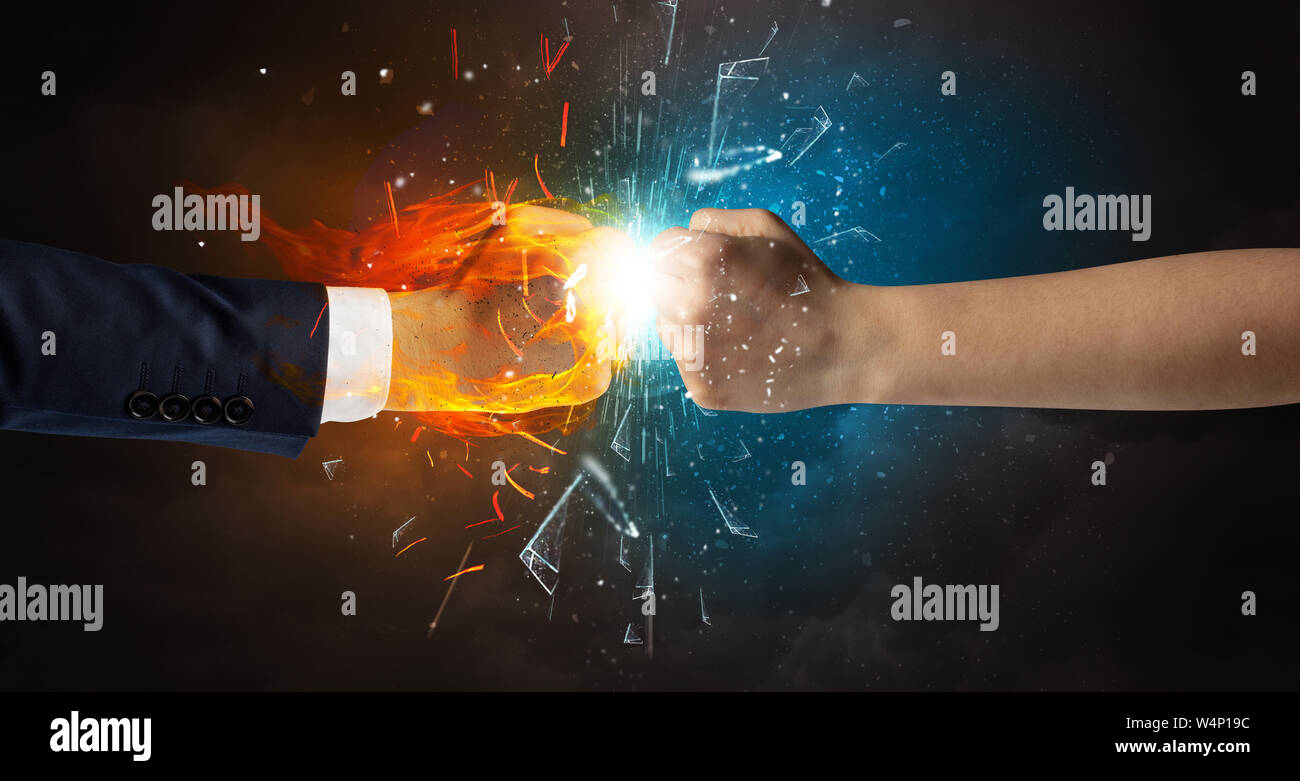 Two hands fighting and breaking glass into small pieces with fire and ...