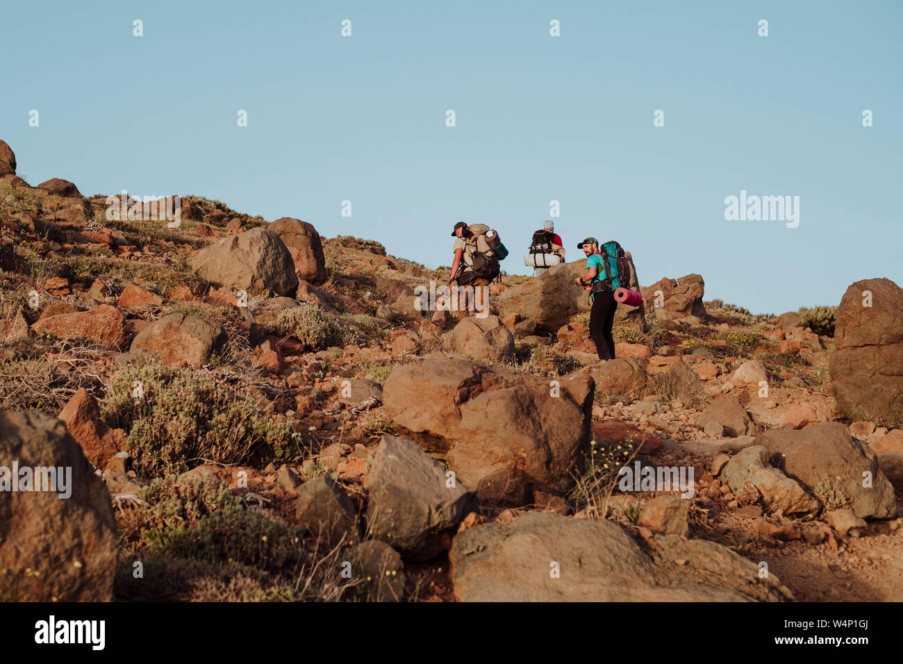 Hikers walking trough the rocks in a volcanic landscape Stock Photo - Alamy