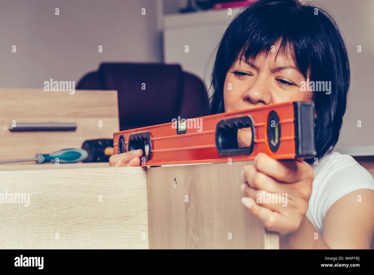 Woman using screwdriver fixing hi-res stock photography and images - Alamy