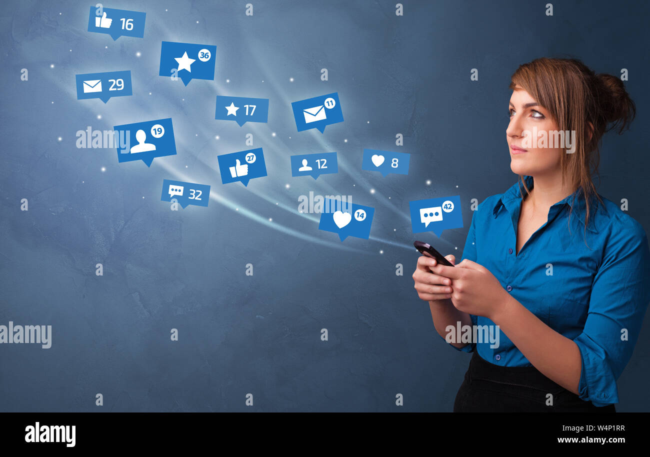 Young person using phone with flying social media icons around Stock ...