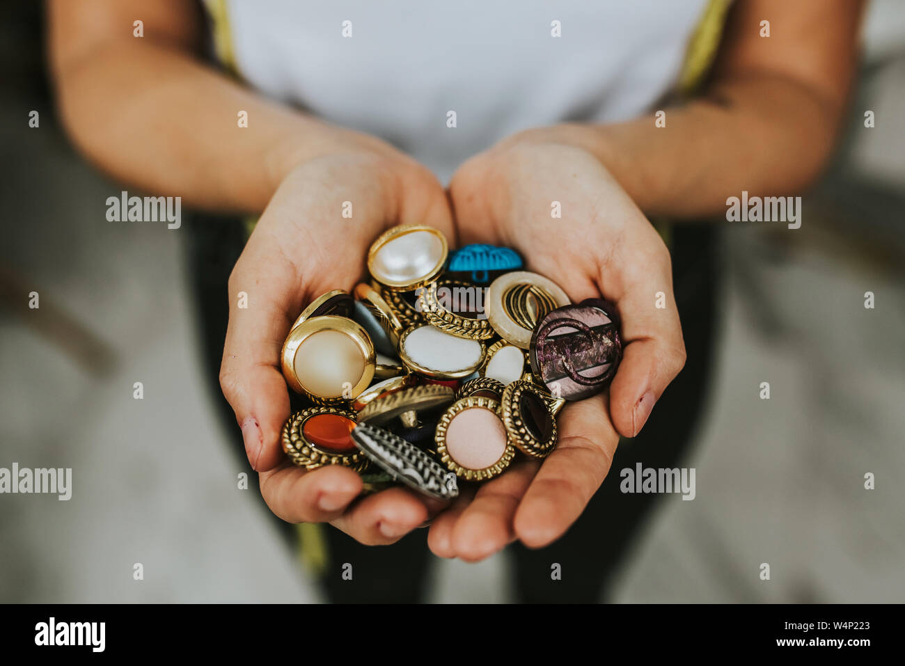 hands holding set of buttons of different shapes and colors Stock Photo ...