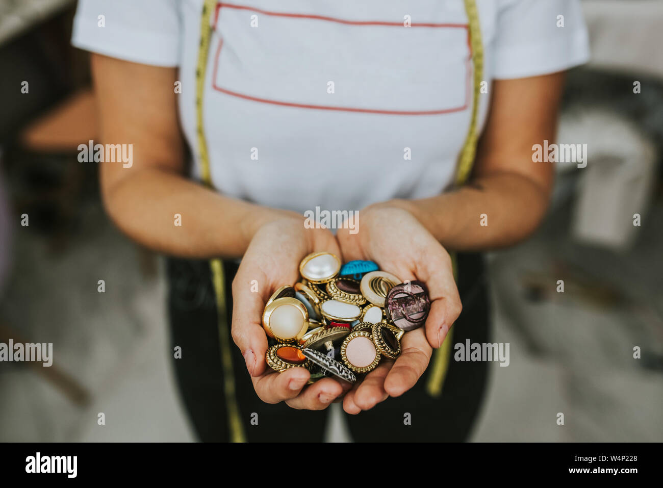 hands holding set of buttons of different shapes and colors Stock Photo ...