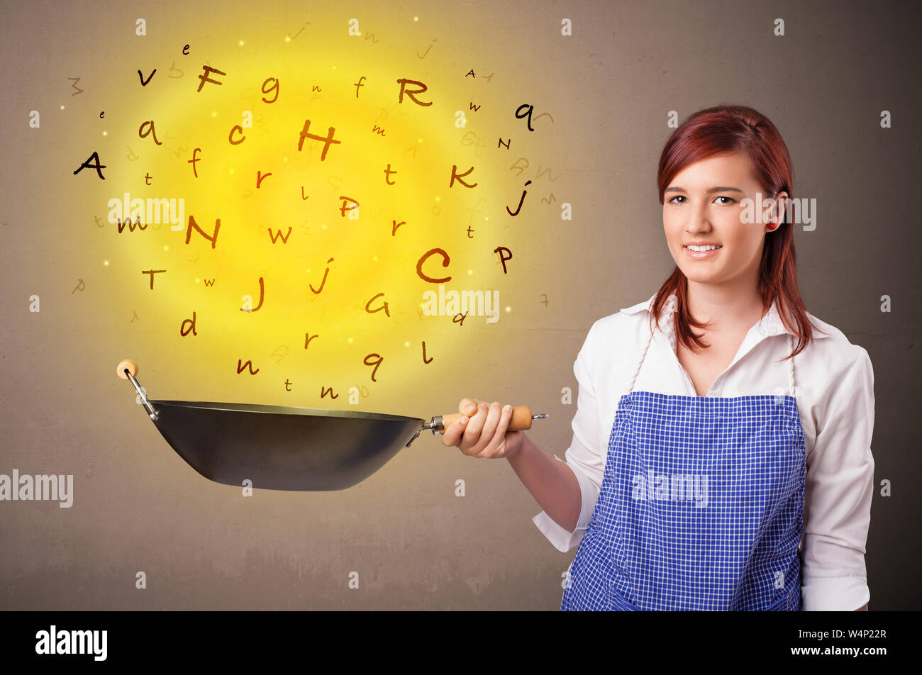 Young person cooking letters in wok Stock Photo - Alamy