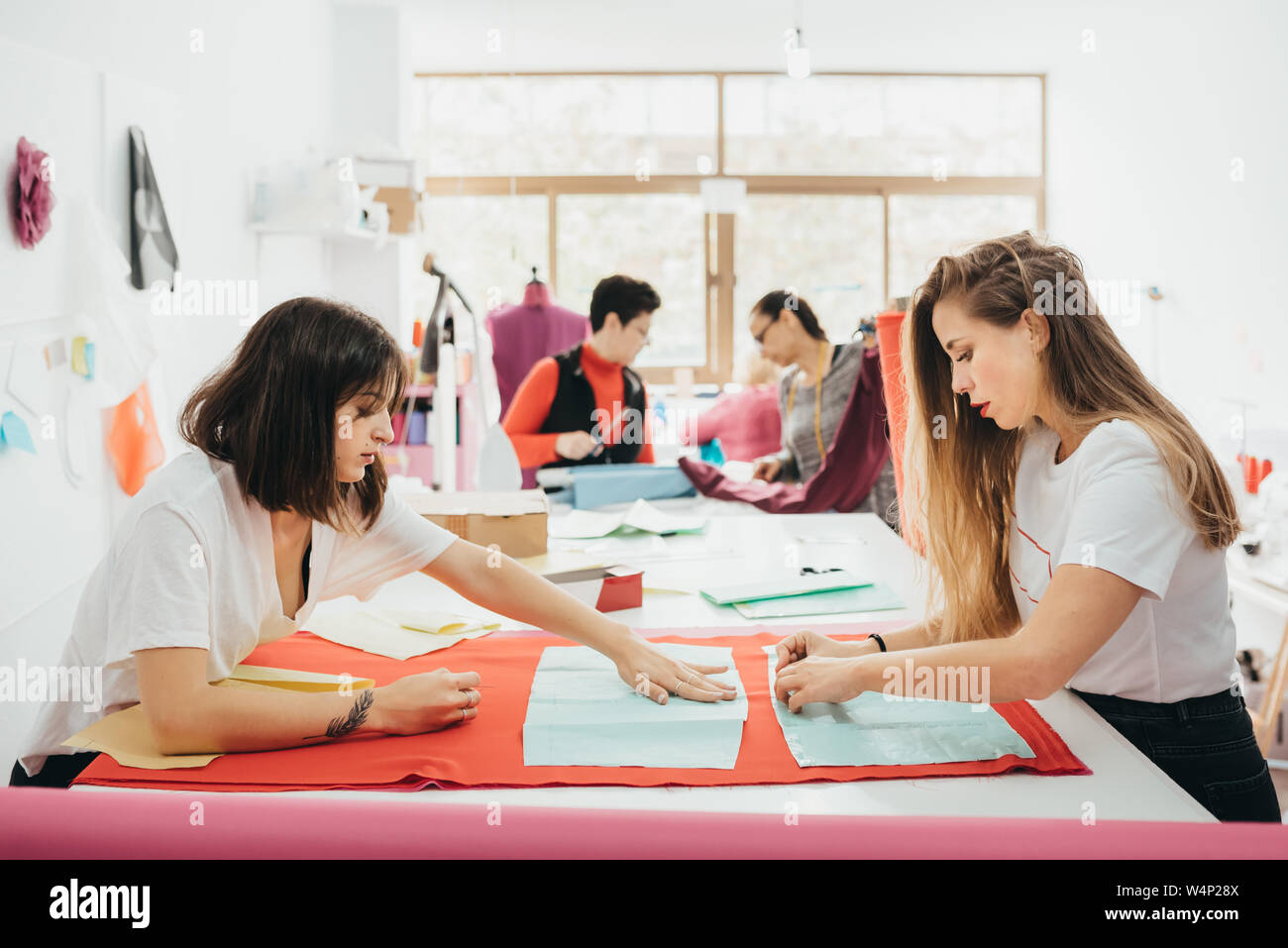 Fashion designers working in the design studio Stock Photo - Alamy
