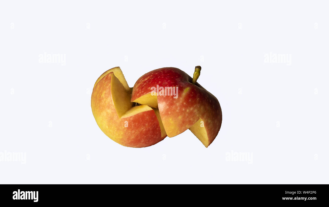 Red, isolated, cut into 2 slices apple on a white background Stock ...