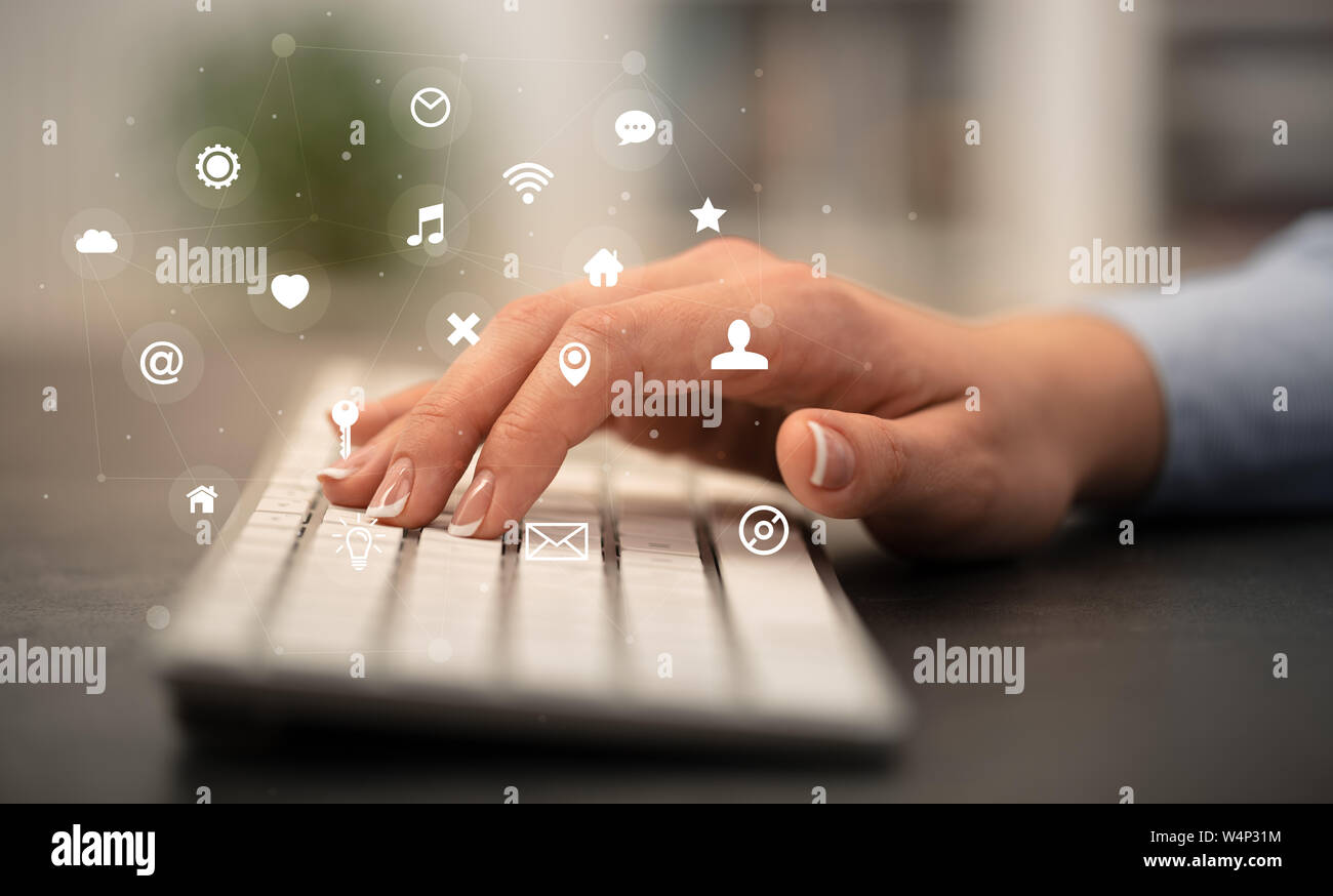 Business woman hand typing on keyboard with application icons around ...