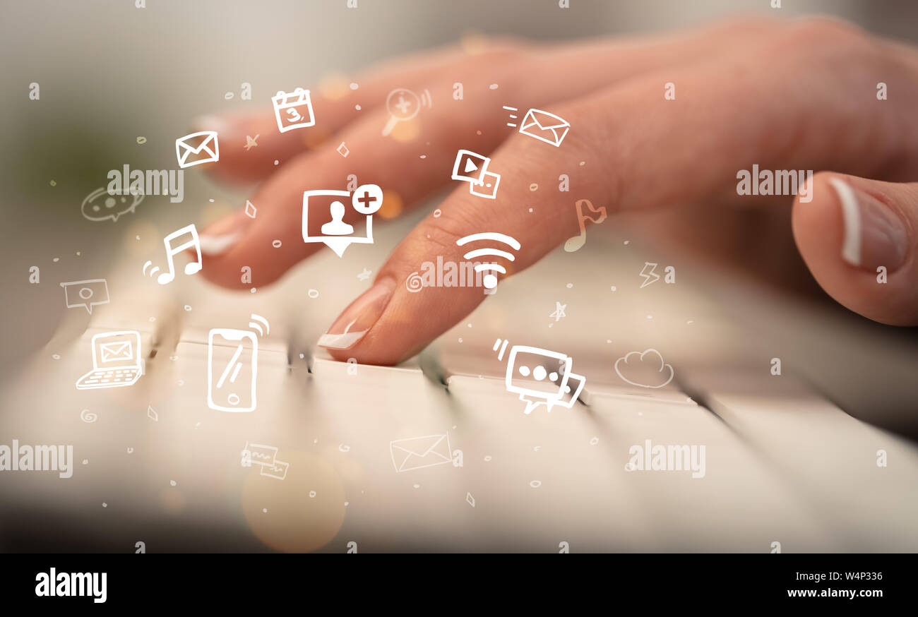 Business woman hand typing on keyboard with drawn application icons ...