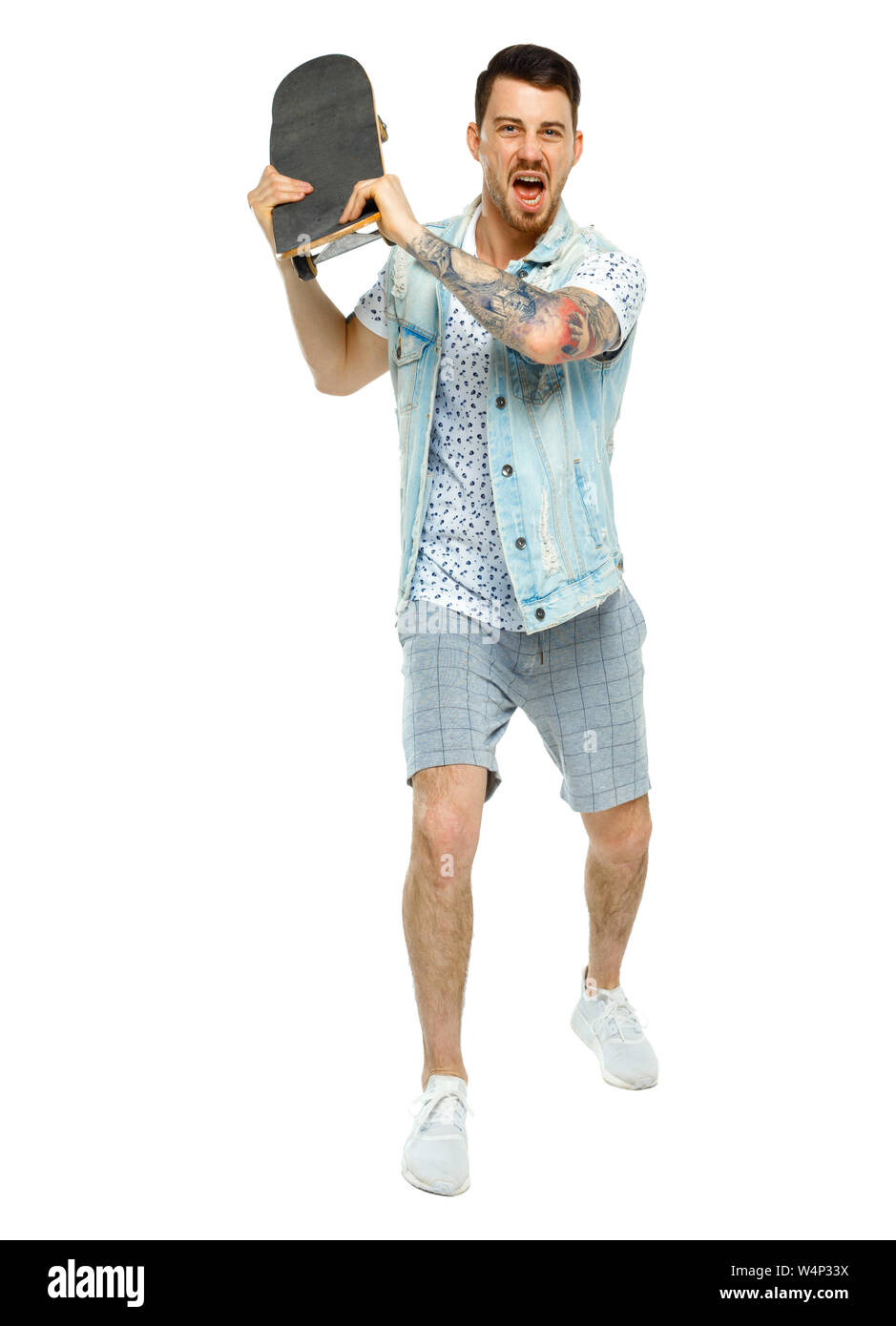 An angry tattooed man attacks. The guy swung to hit the skateboard ...