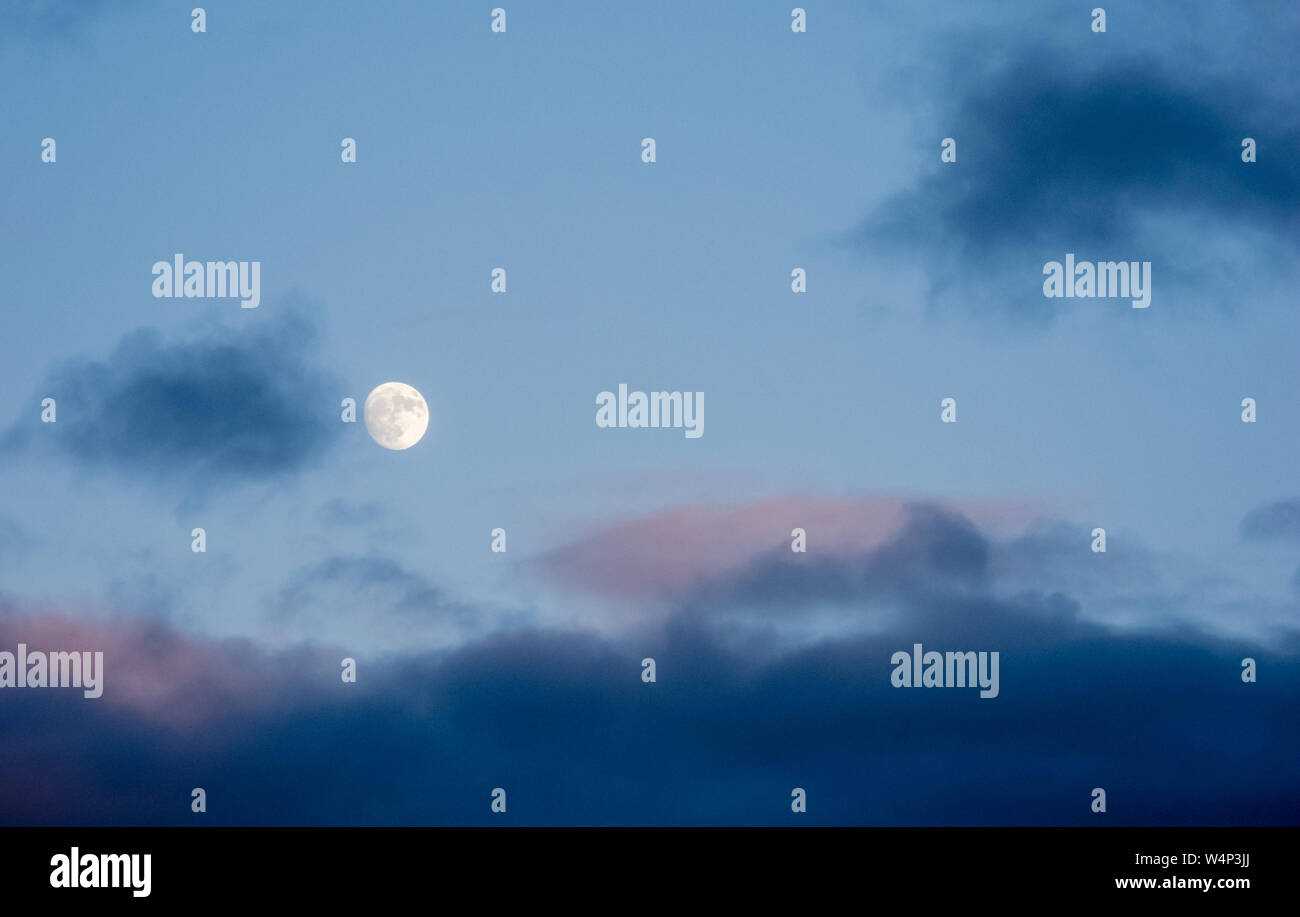 Moon and evening sky with clouds Stock Photo - Alamy