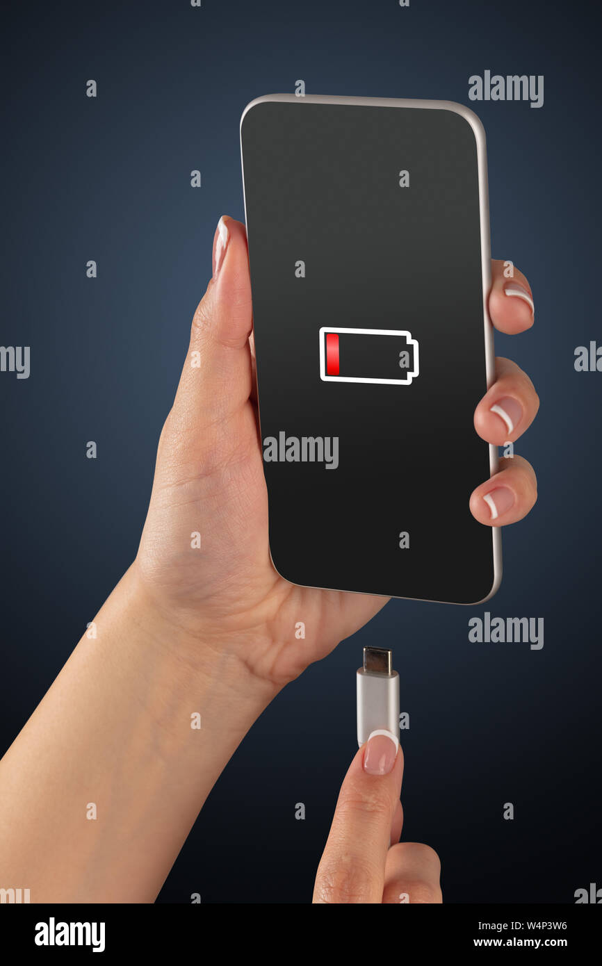 Elegant hand charging cellphone with low battery Stock Photo - Alamy