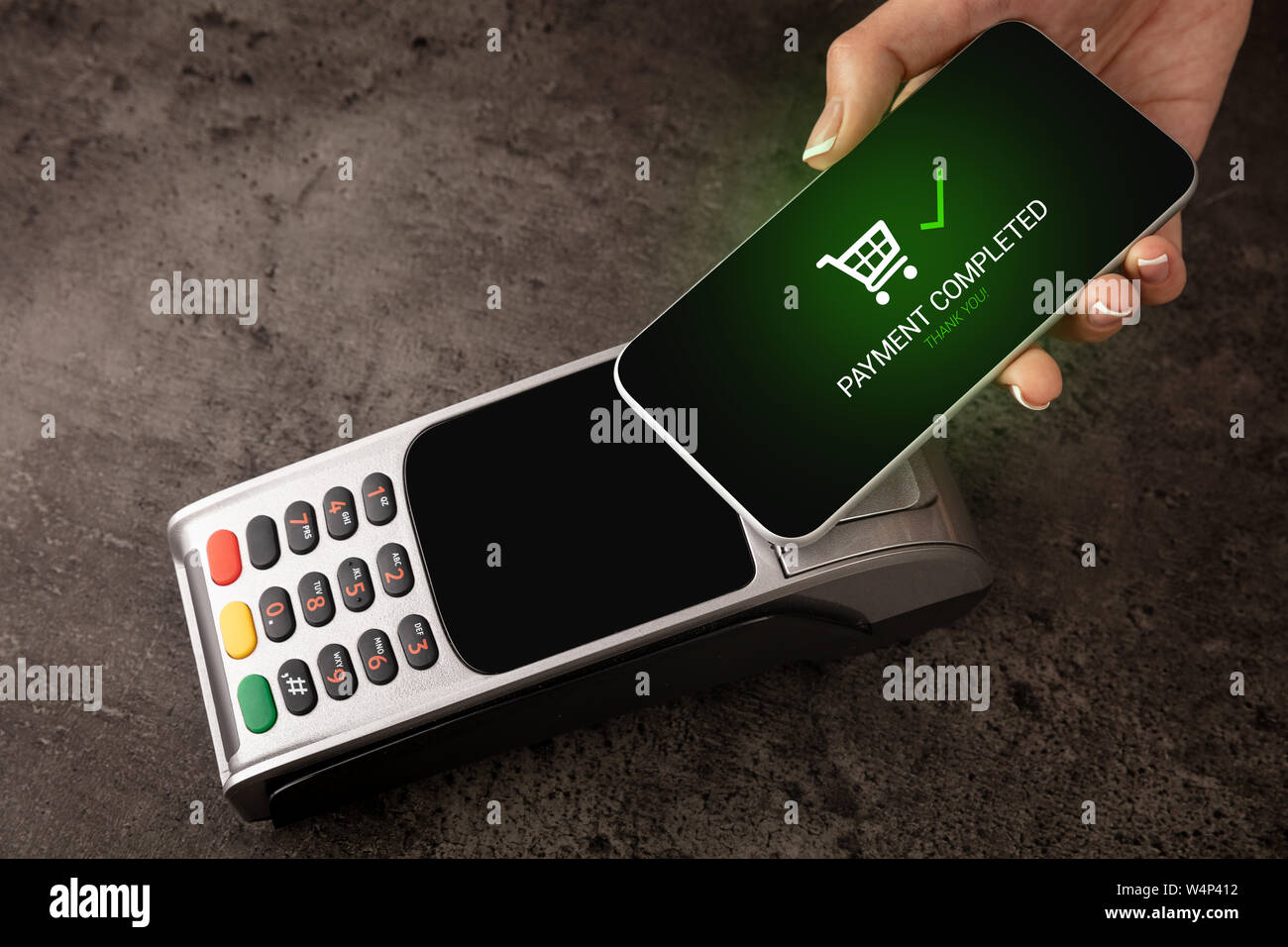 Mobile payment accepted on terminal Stock Photo - Alamy