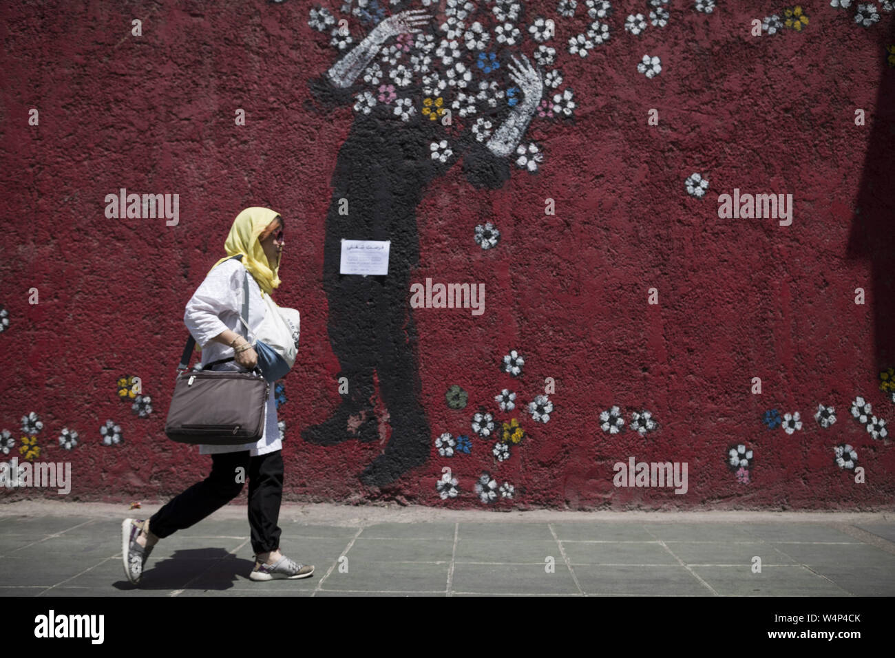 July 24, 2019, Tehran, Tehran, Iran: People walk past a mural in a ...