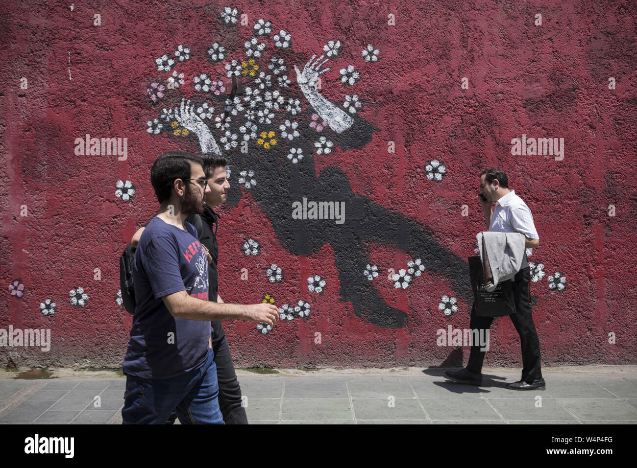 July 24, 2019, Tehran, Tehran, Iran: People walk past a mural in a ...
