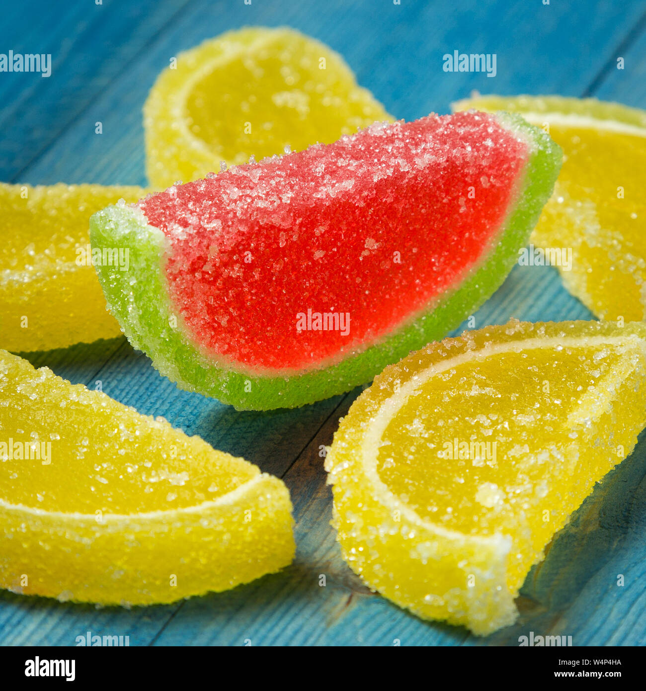 Marmalade in the form of slice of watermelon standing among yellow ...