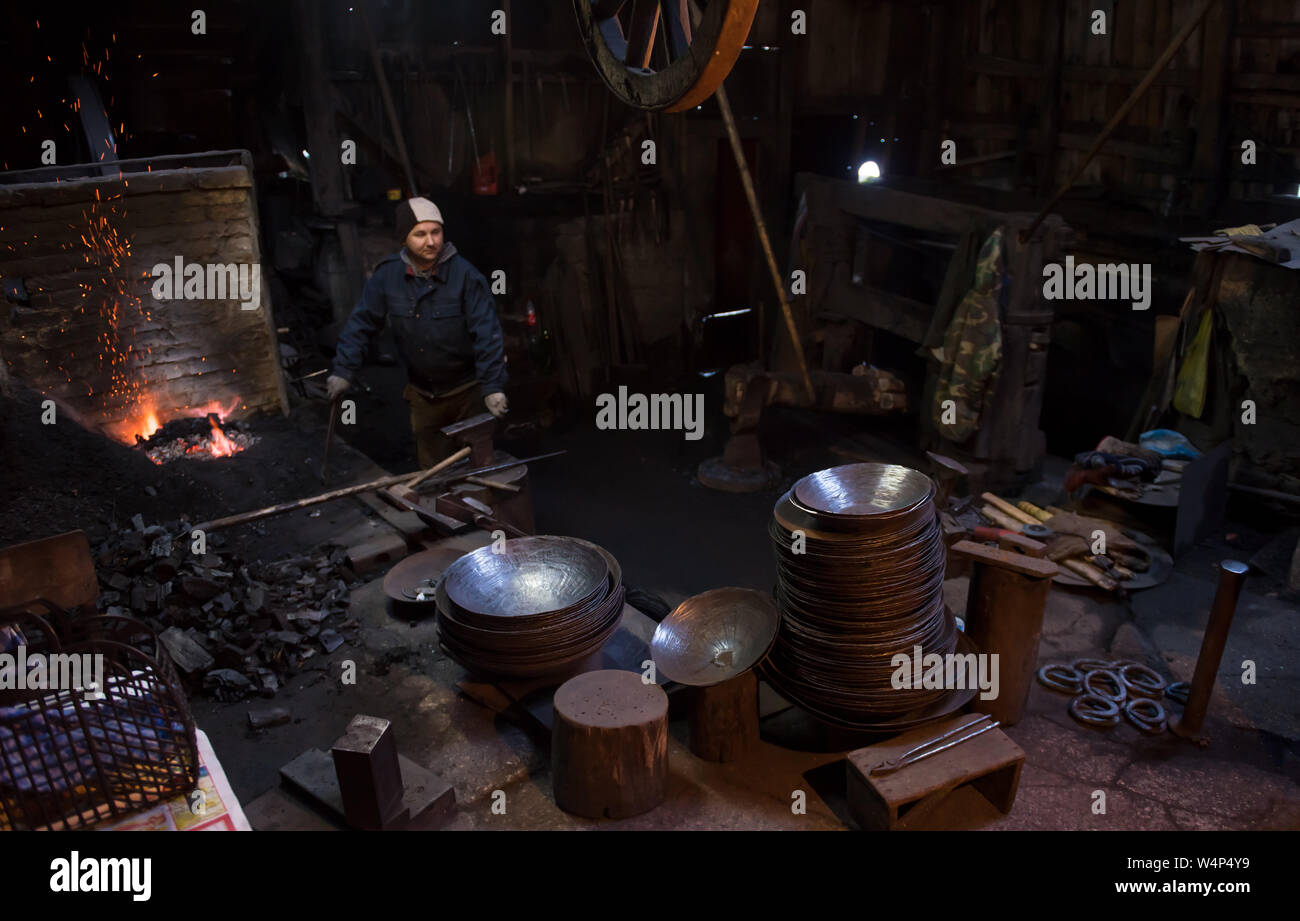young traditional Blacksmith working with open fire The blacksmith ...