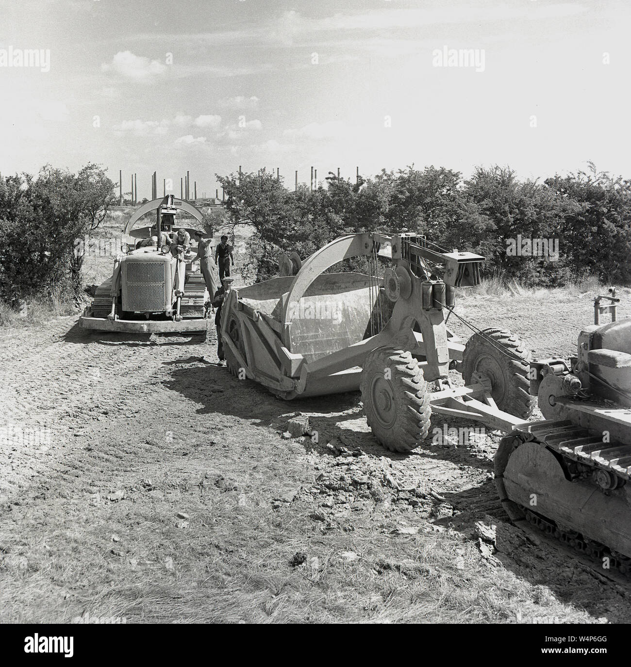 1950s, historical, workers and earth-moving equipment outside in the ...