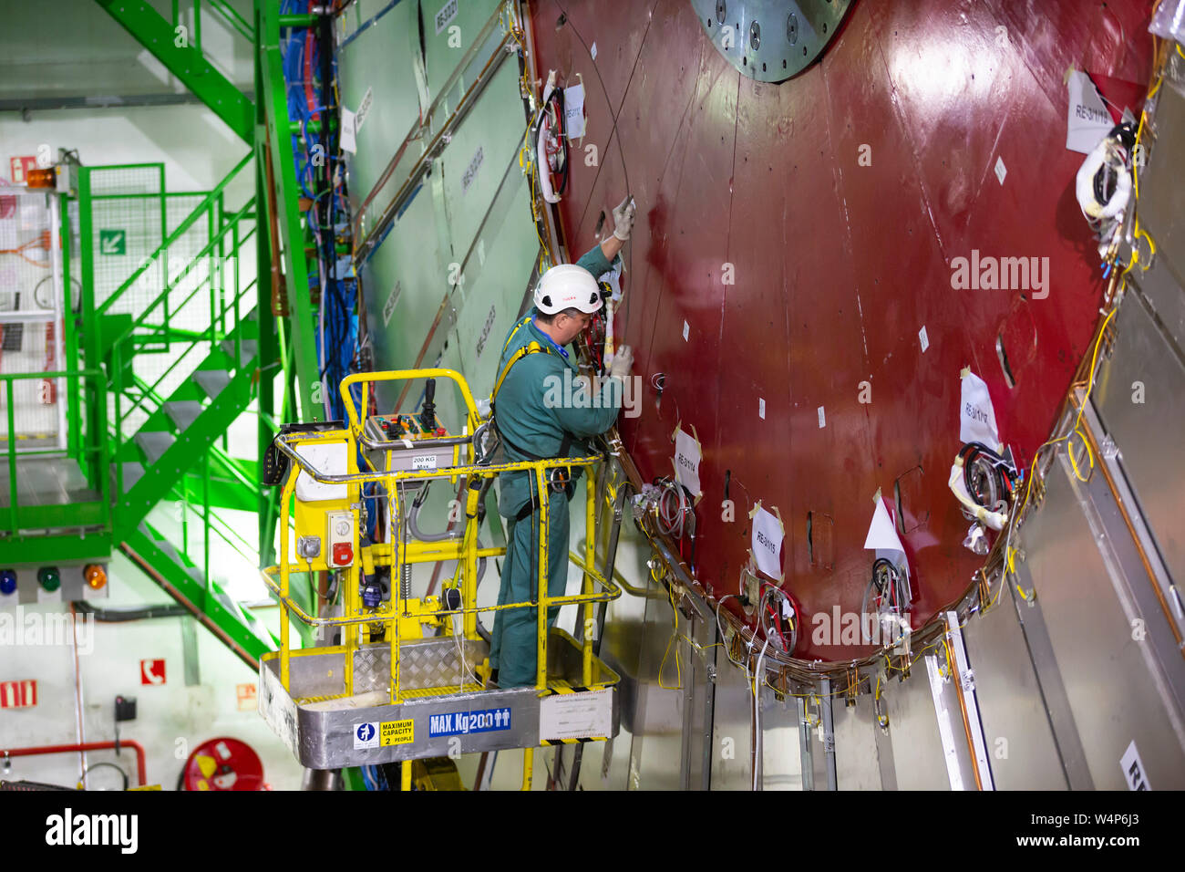 CERN, France - 25 June, 2019: A workers repairs part of The Large ...