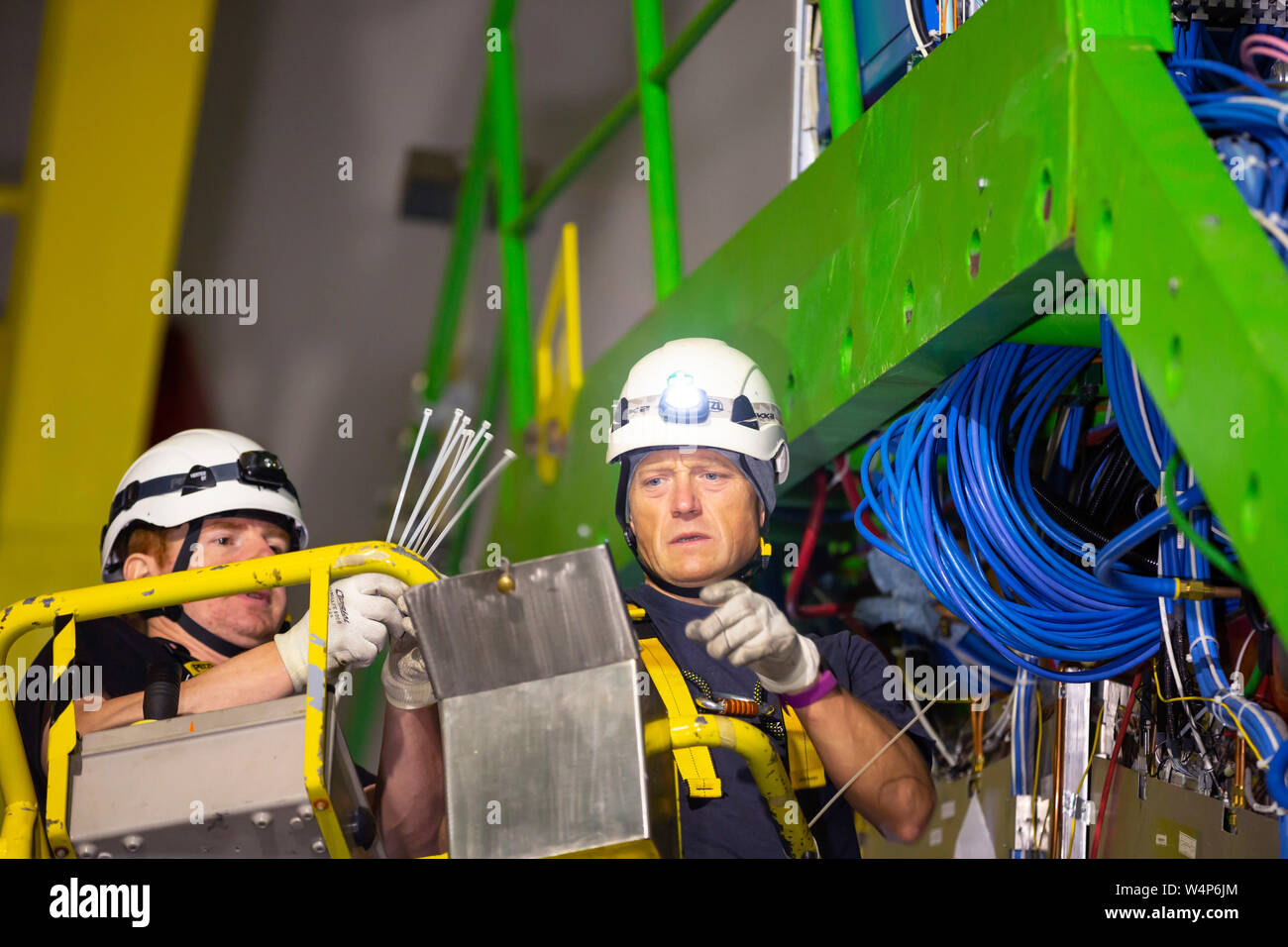 CERN, France - 25 June, 2019: Workers repair part of The Large Hadron ...