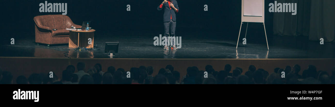 cropped image .lecturer standing on the podium during a business ...