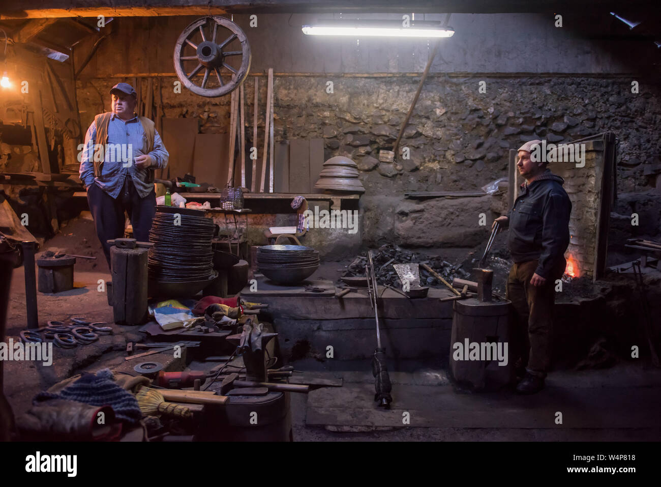 portrait of two generations traditional confident blacksmith workers at ...