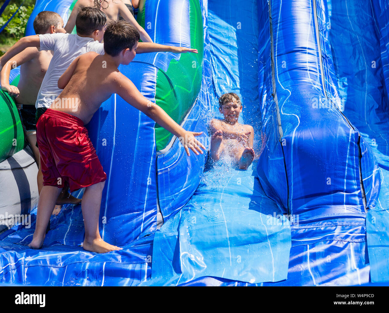 The look on the face says it all as kids come down the waterslide to ...