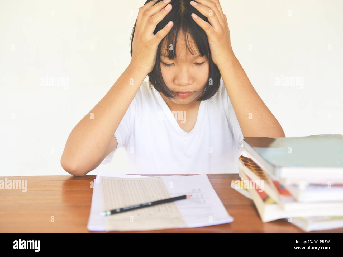 exam stress / education young female college in class taking notes and ...