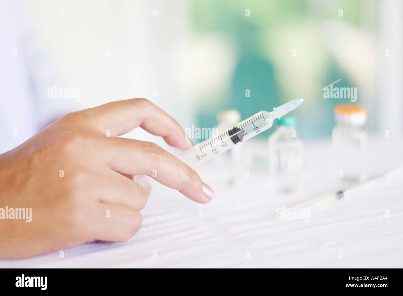 Syringe medication injection and needle in hand nurse asian for giving ...