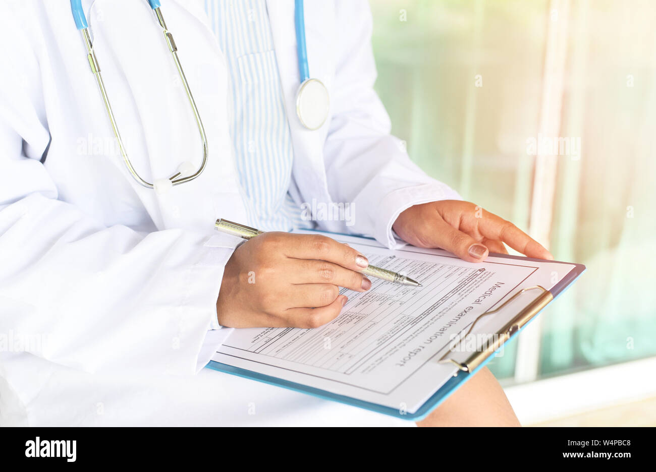 doctor woman asian note on medical record - medical examination report ...