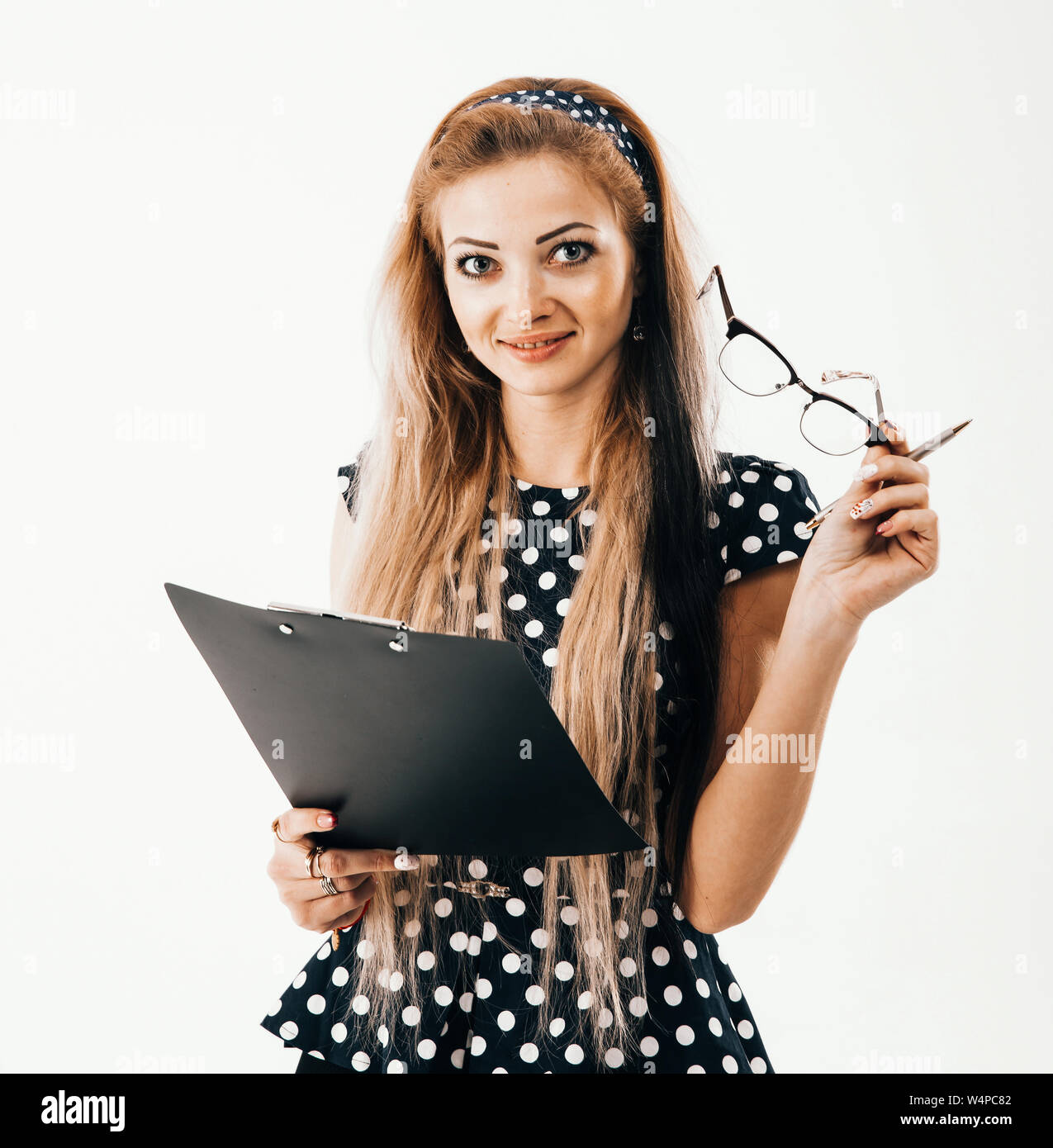 portrait of confident female administrator in glasses with papers on ...