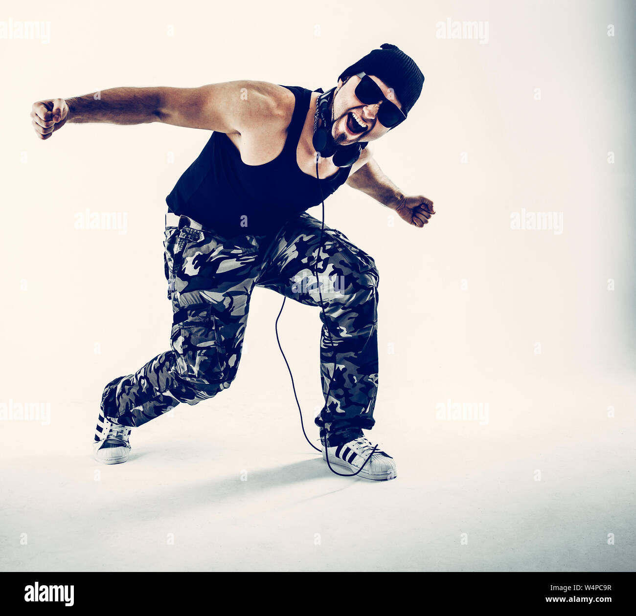 energetic and charismatic guy rapper dances break dance.the photo has a ...