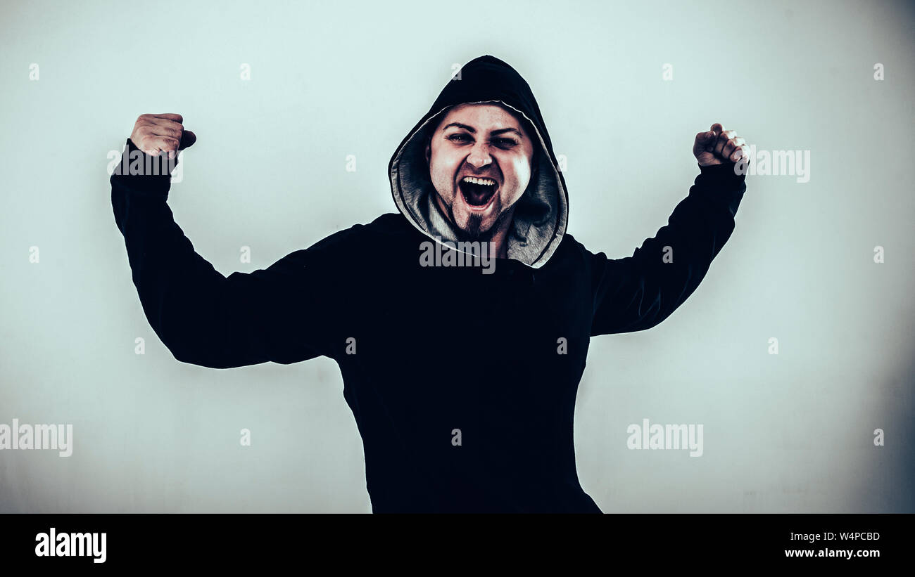 energetic guy rapper on a light background.the photo has a empty space ...