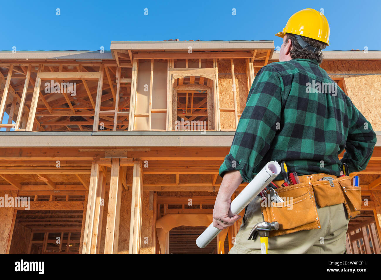 Contractor In Front New House Wood Framing at Construction Site Stock ...