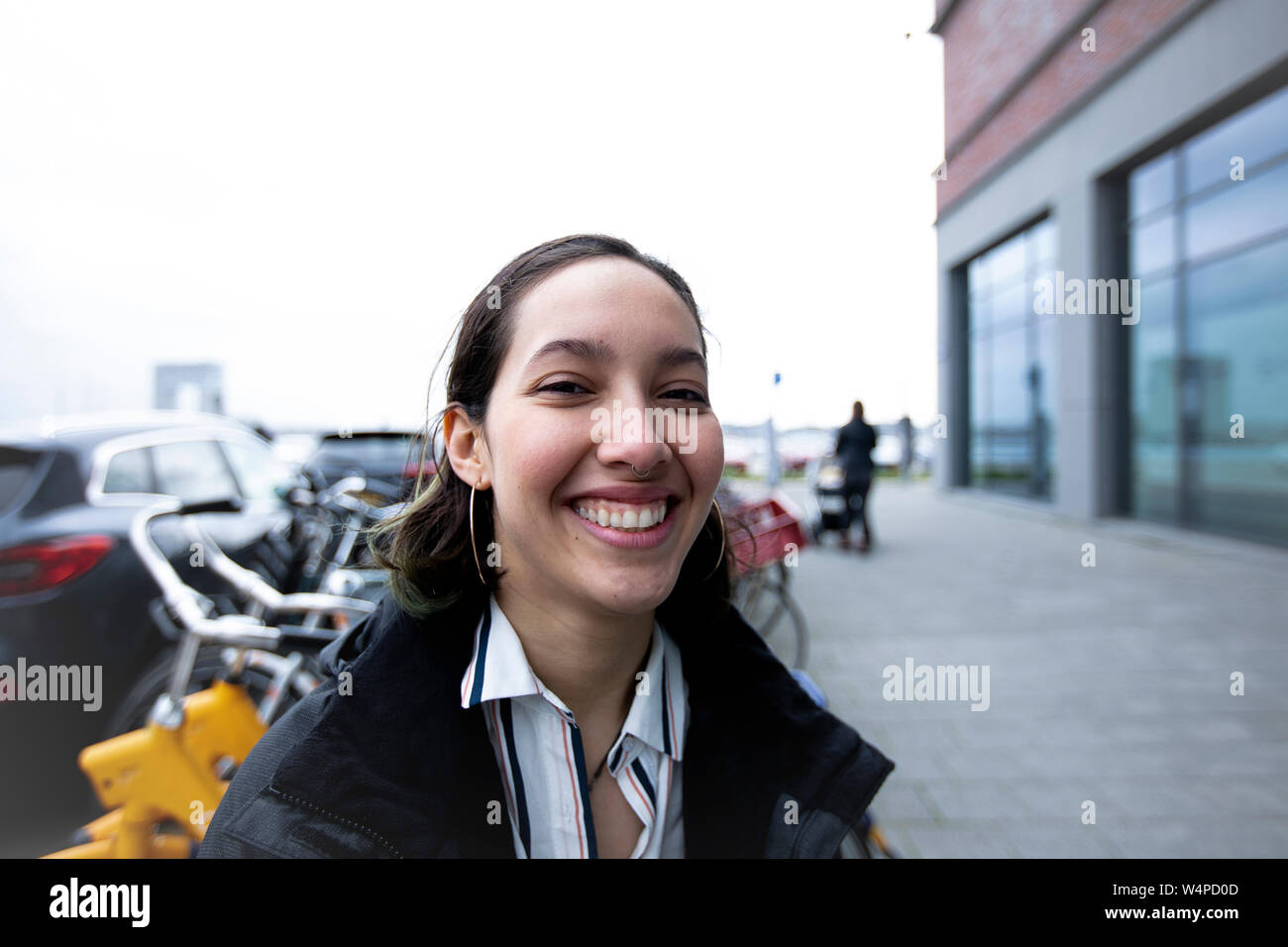 Happy young woman going to work. Outside office building Stock Photo ...