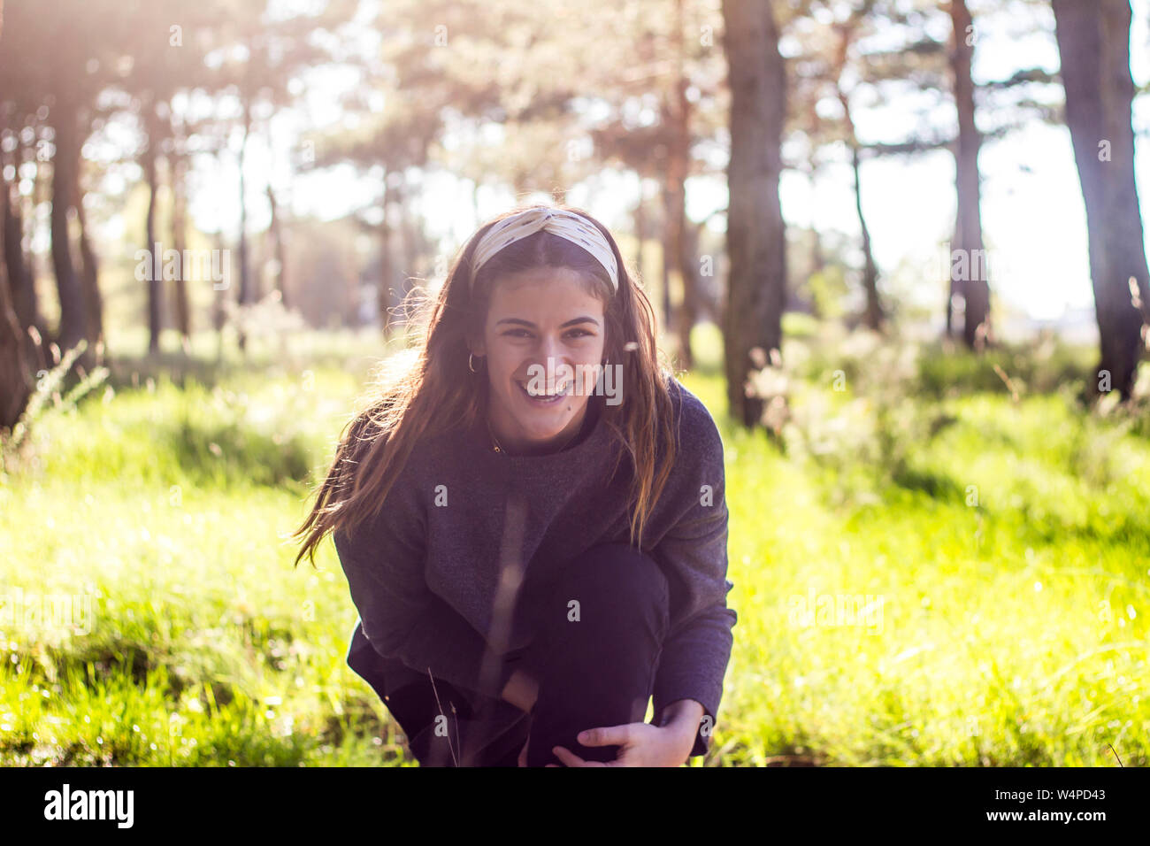 girl smiling in the forest on nature at sunset Stock Photo - Alamy