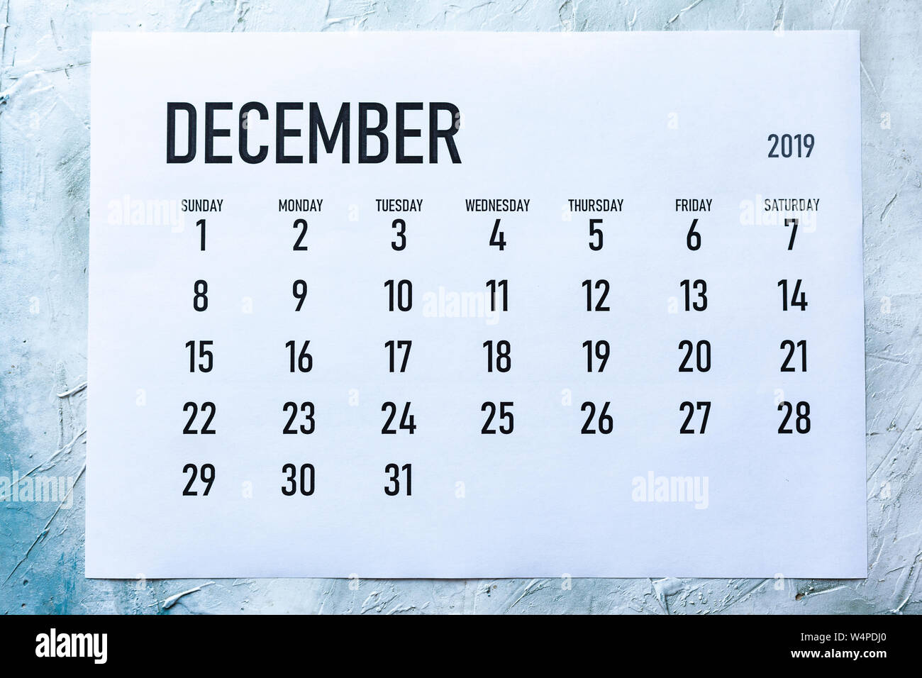 Simple 2019 December monthly calendar on table with office supplies ...