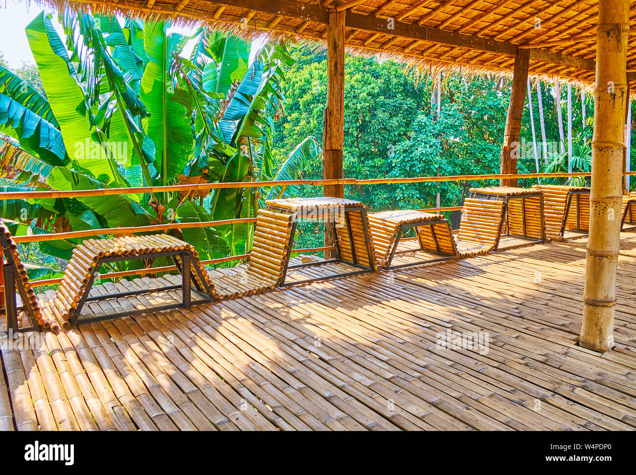 The shady bamboo terrace with tables in benches located atop the hill ...