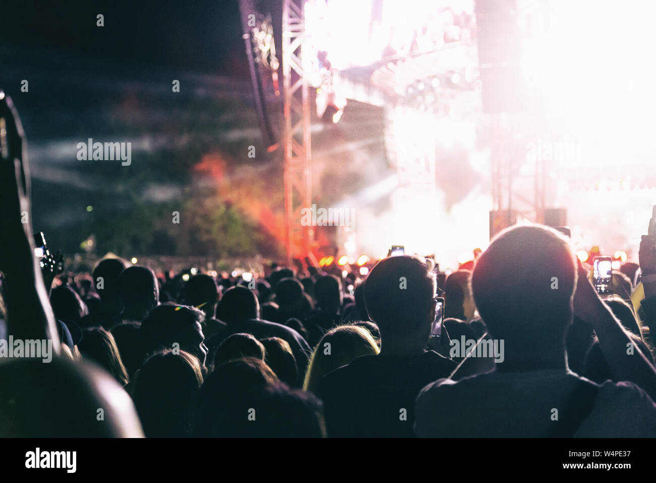 Concert crowd watching rock band performance on the big stage. The ...